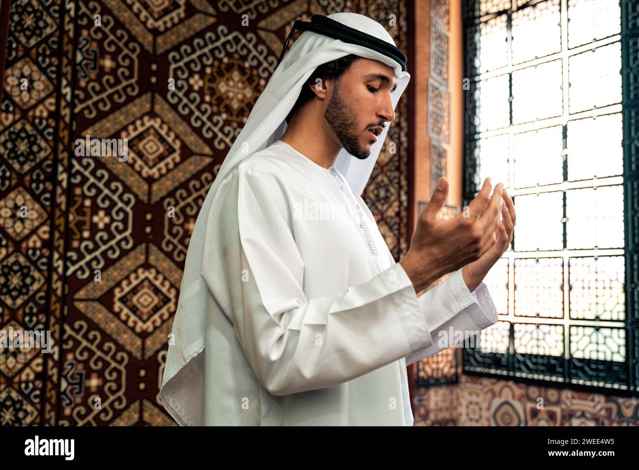 Man from emirati wearing kandura outfit spending time in an arabian ...