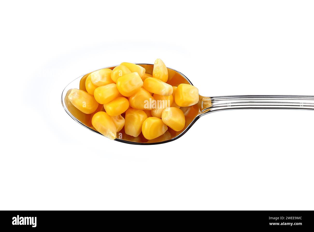 sweetcorn in a spoon isolated white background.jpg Stock Photo - Alamy