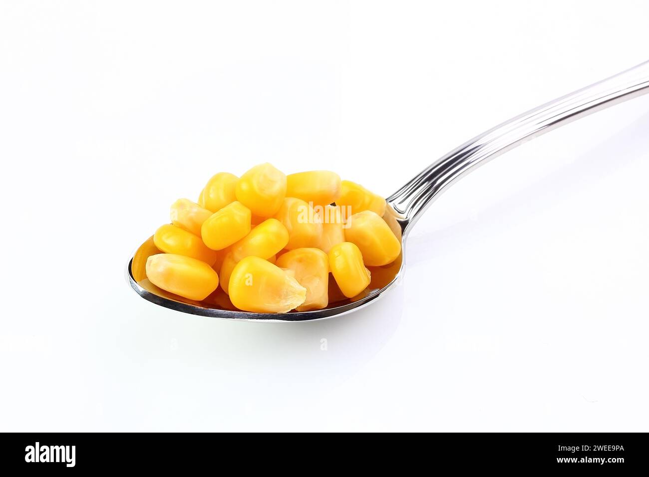 corn in spoon isolated white background Stock Photo - Alamy
