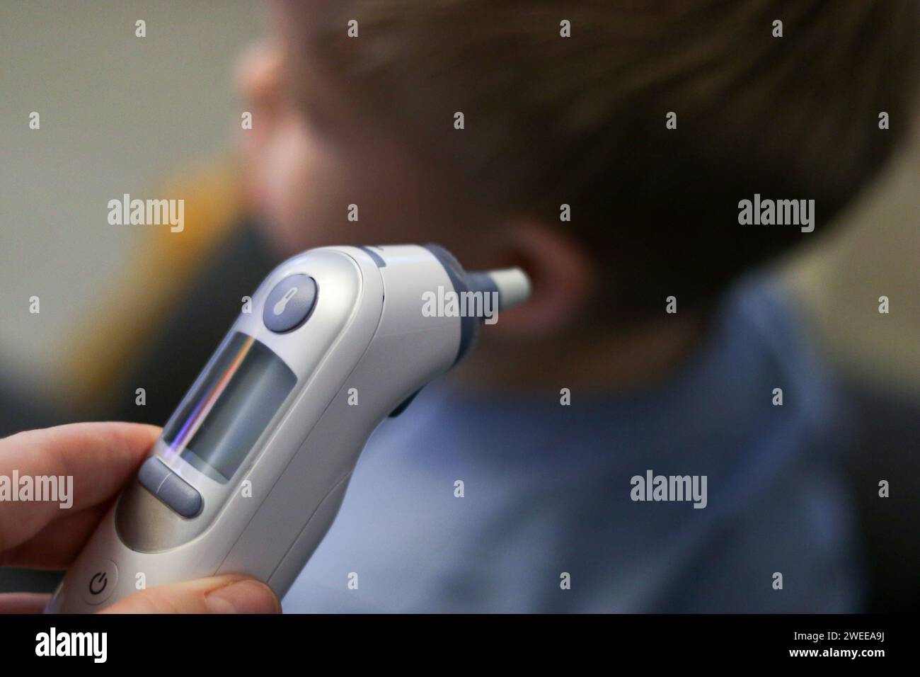 Close-up thermometer. Mother measuring temperature of her ill kid. Sick child with high fever in ...