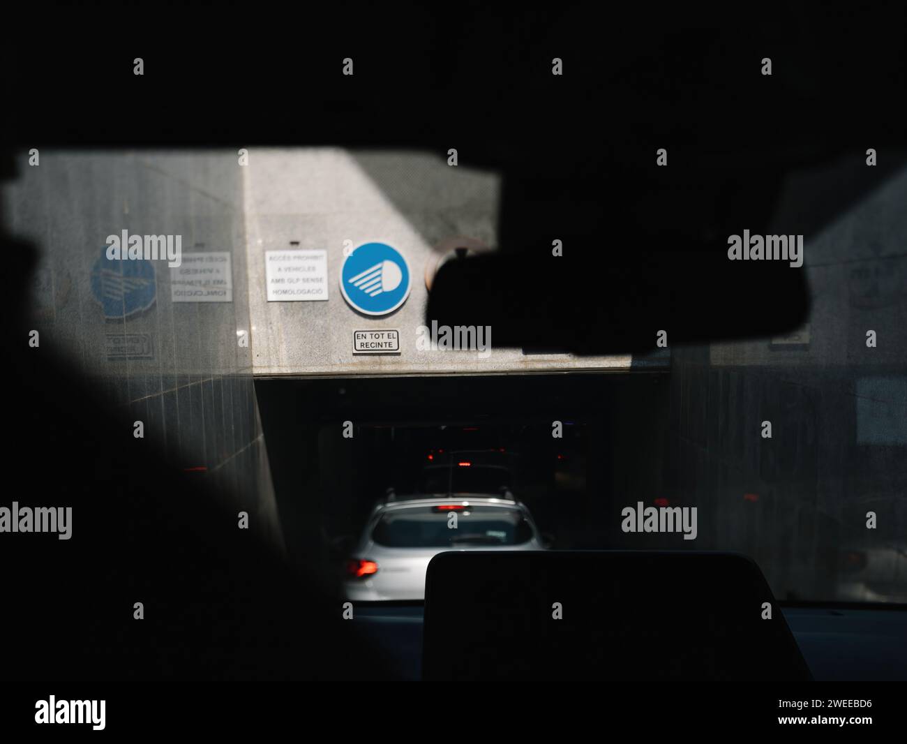 The entrance to a Spanish underground garage featuring a dedicated sign ...