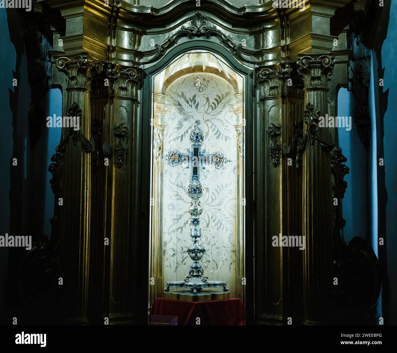A captivating photo capturing a gold and white altar adorned with a ...