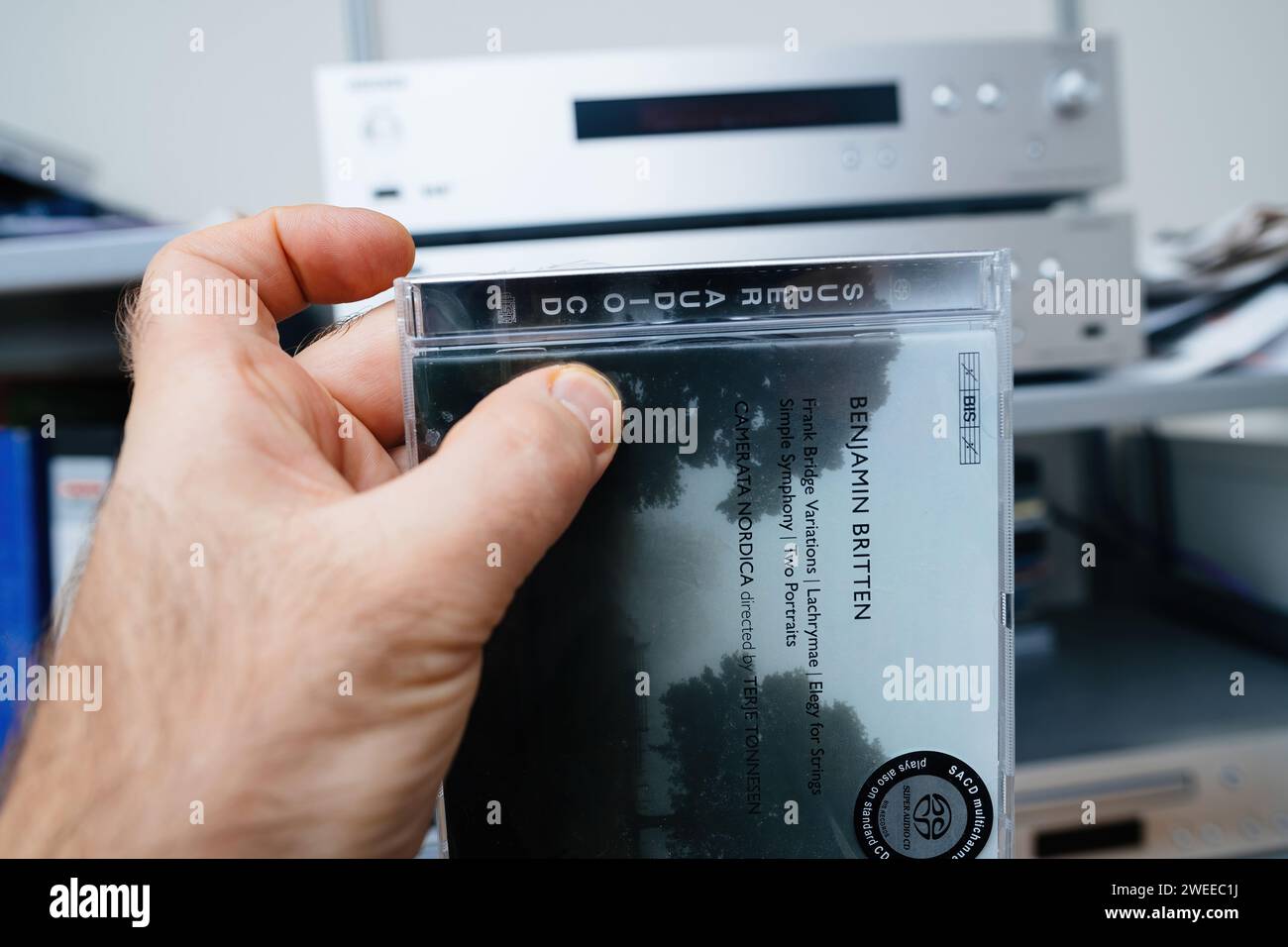Paris, France - Dec 28, 2023: A hand points towards the SACD cover in ...