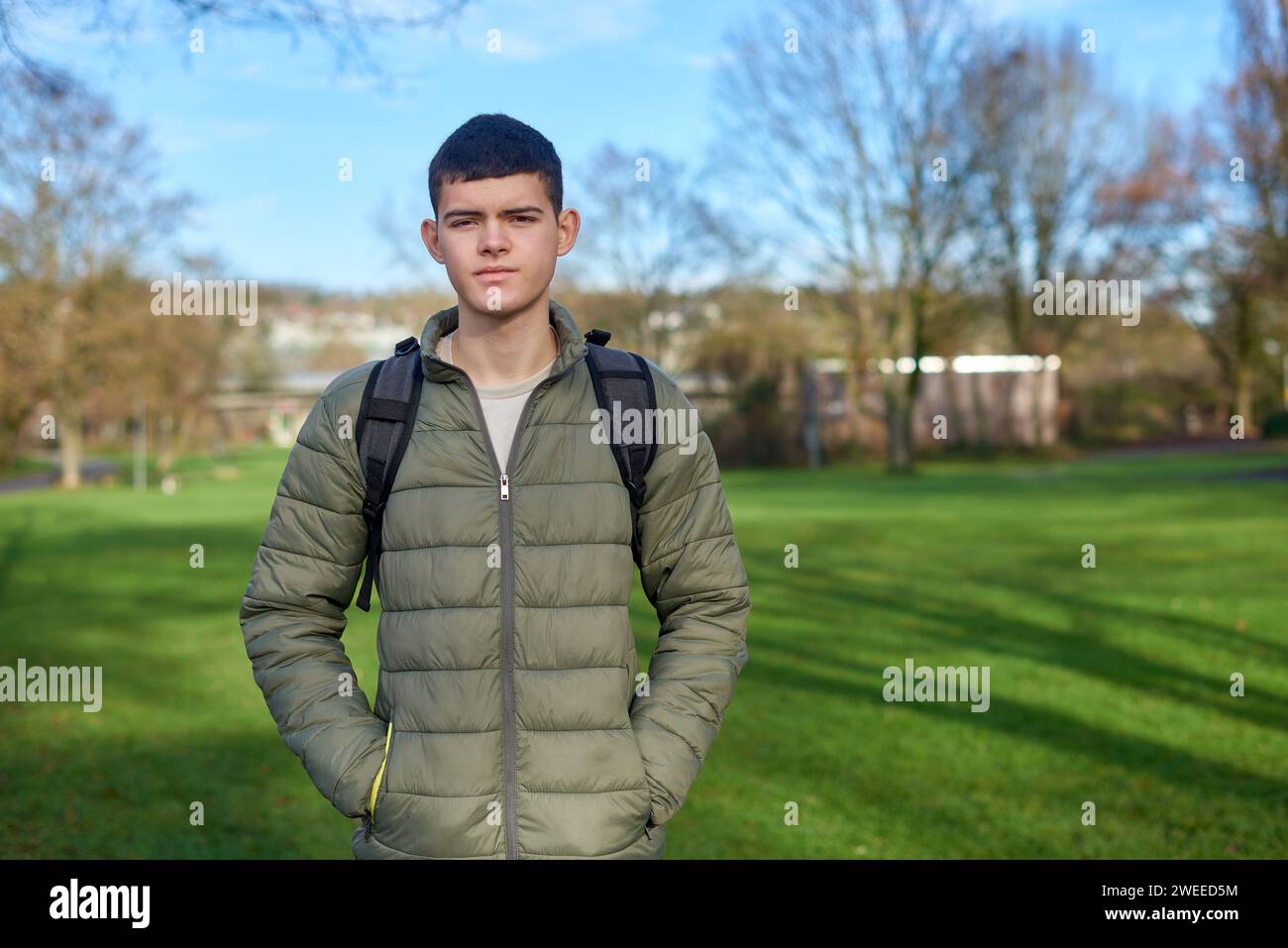 Youthful Elegance: Beautiful 17-Year-Old Boy Standing in the Autumn Park with Lush Green Lawn ...