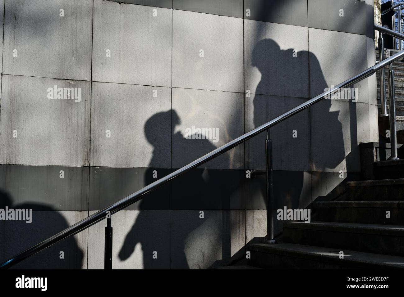 Shadows on the wall of two men coming down the steps of a passage Stock ...