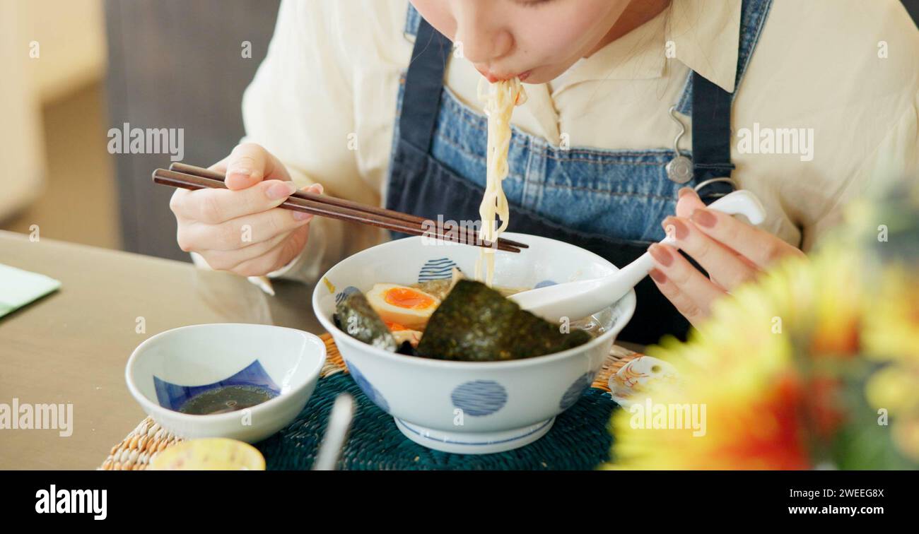 Hungry woman, eating ramen and restaurant with chopsticks, noodles and ...