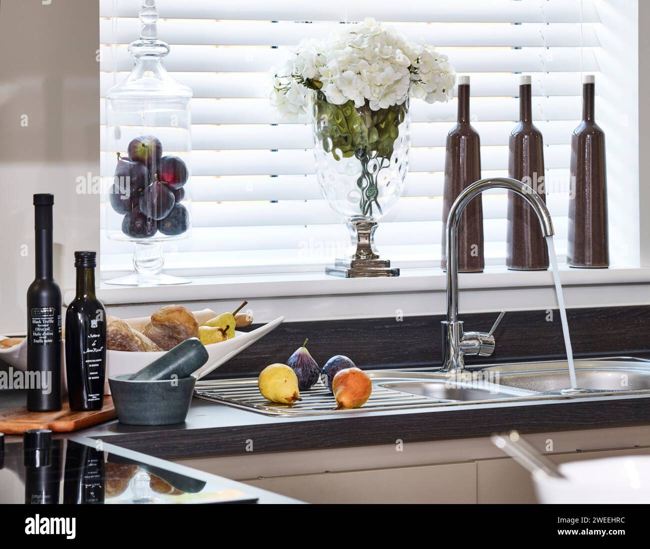 Kitchen sink with running water from tap Stock Photo - Alamy