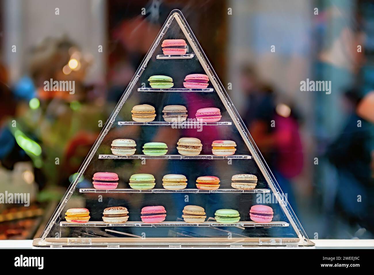Pyramid of macaroons in a variety of colors seen through the window ...
