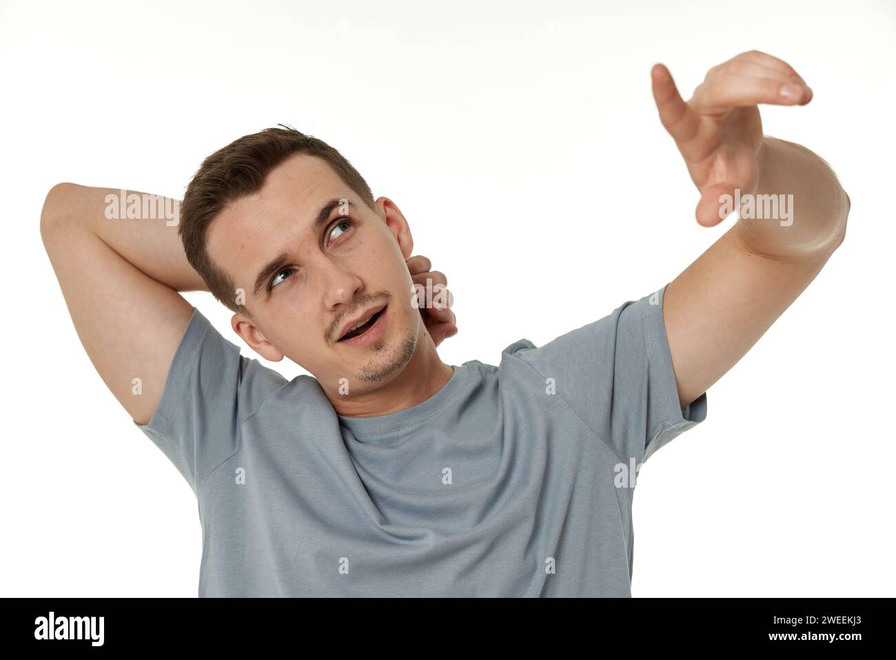 happy guy looking up and pointing up on white studio background Stock ...