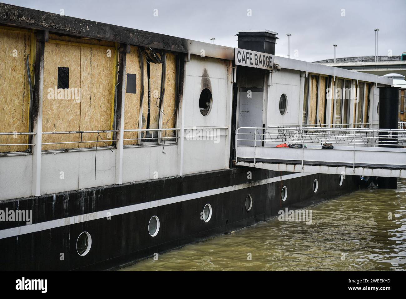 This photograph shows a burnt boat on the Seine River in Paris on ...