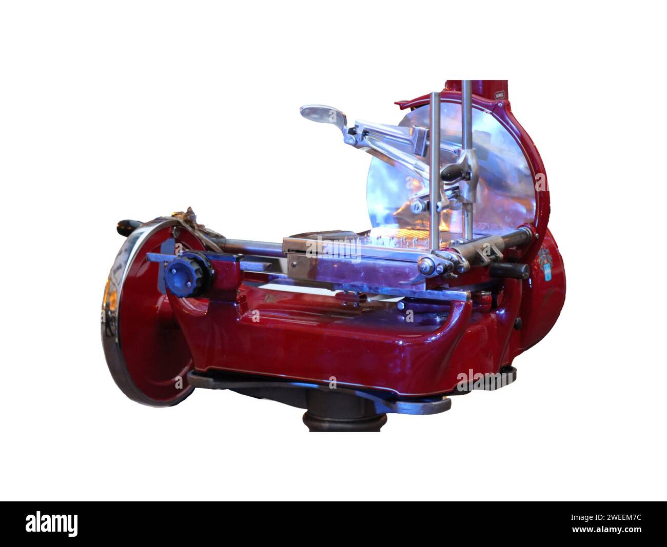 A red industrial machine is situated on a white background with one of ...