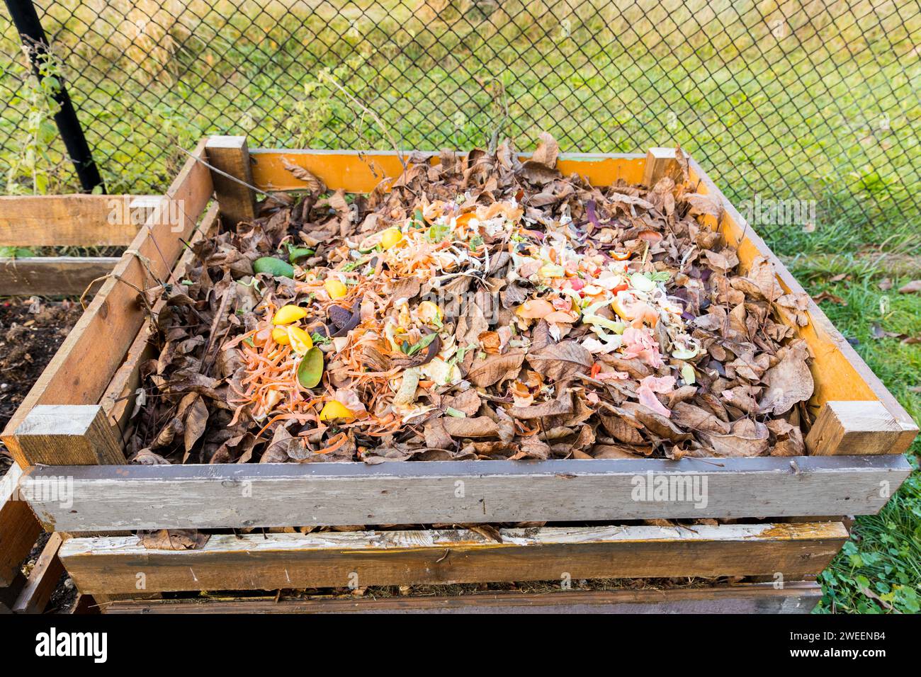 A composter made of wooden boards filled with bio-waste from the ...