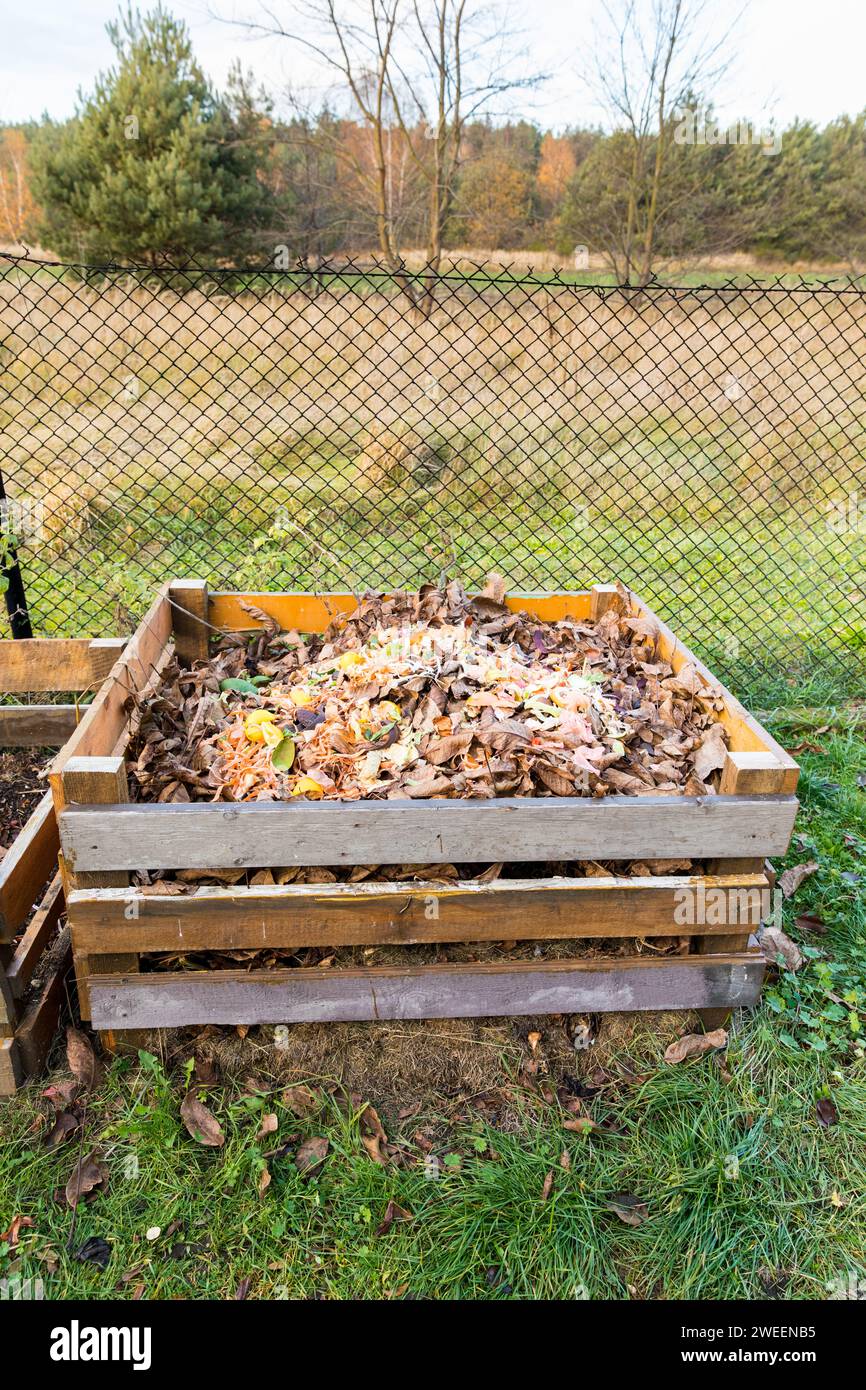 A composter made of wooden boards filled with bio-waste from the ...
