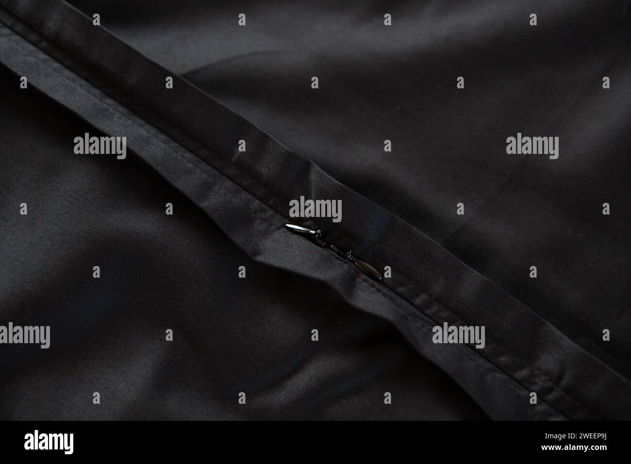 Texture of black crumpled bed linen with zipper Stock Photo - Alamy