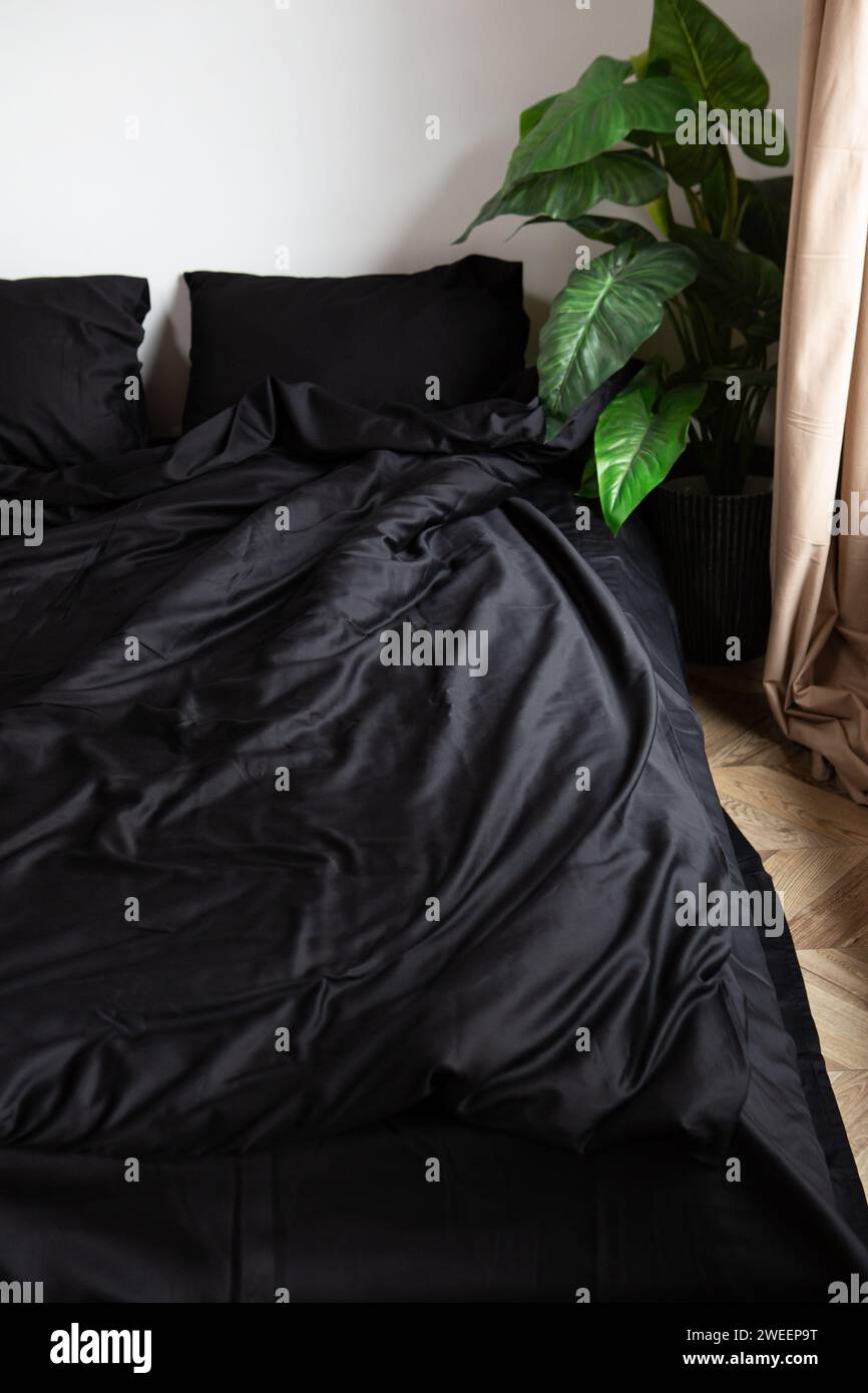 Texture of black crumpled bed linen on the bed Stock Photo - Alamy