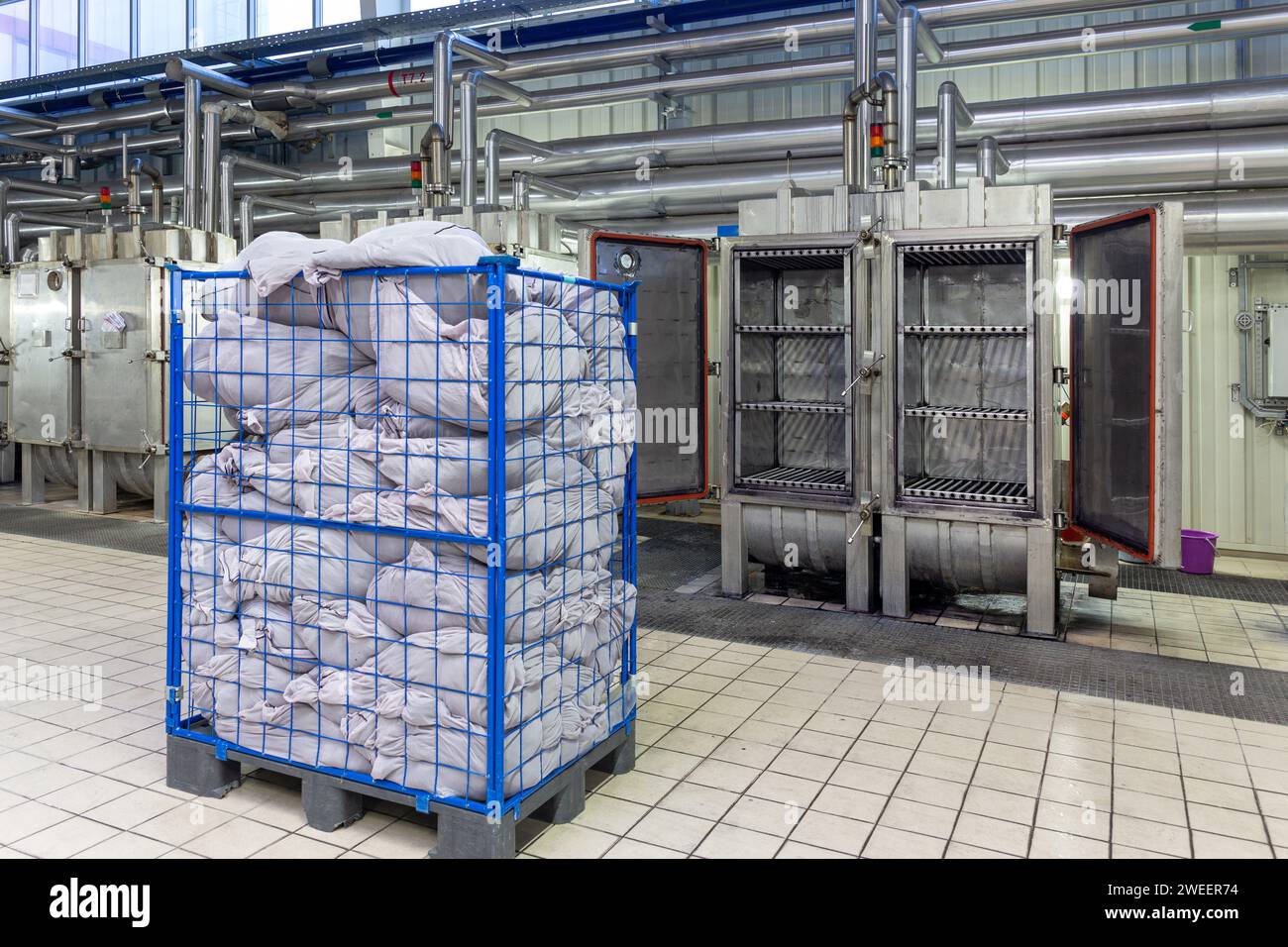 drying chamber for yarn with open doors and trolley with wet production ...
