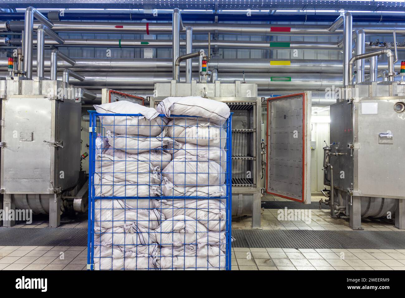 drying chamber for yarn with open doors and trolley with wet production ...