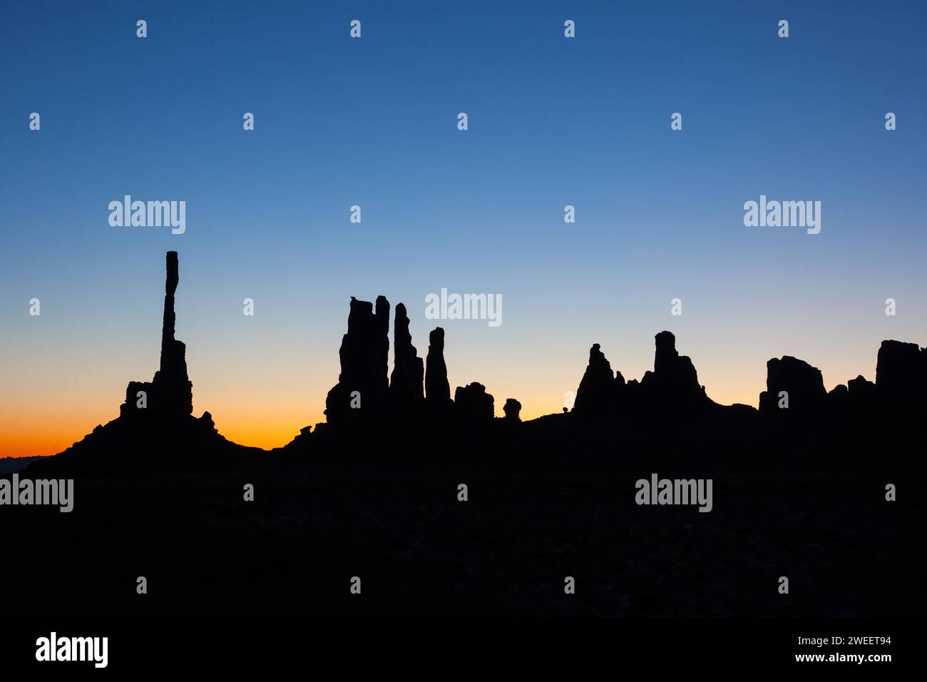 The Totem Pole and the Yei Bi Chei in silhouette before dawn in the ...