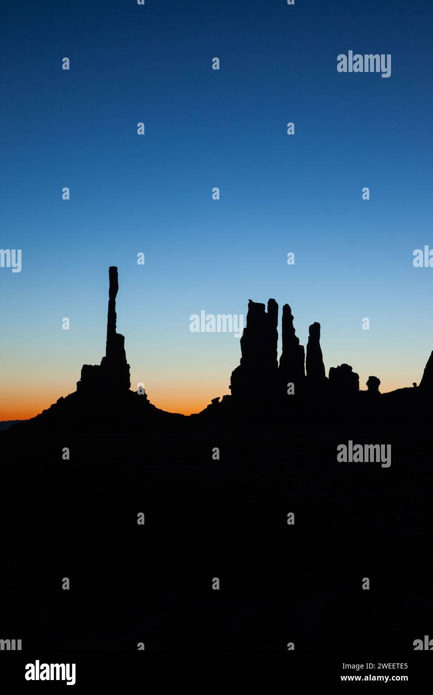 The Totem Pole and the Yei Bi Chei in silhouette before dawn in the ...