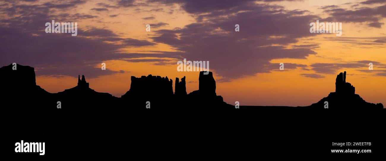 Sunrise silhouette of the Utah monuments in the Monument Valley Navajo ...