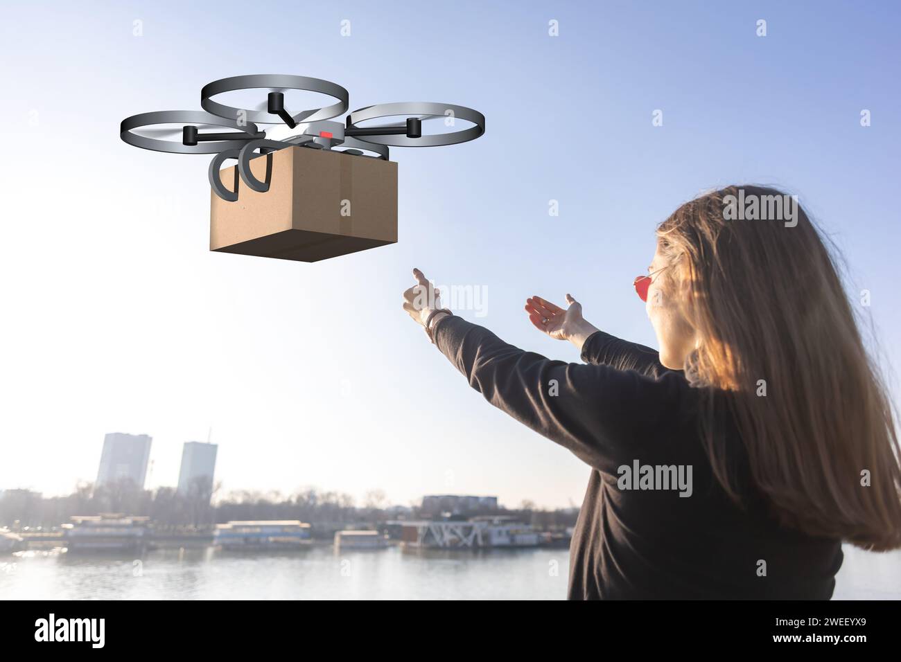woman sending parcel with drone delivery service Stock Photo - Alamy