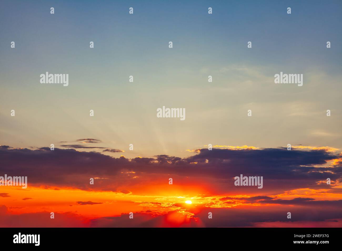 Sunset sky background with clouds and sun rays. Beautiful nature scene ...
