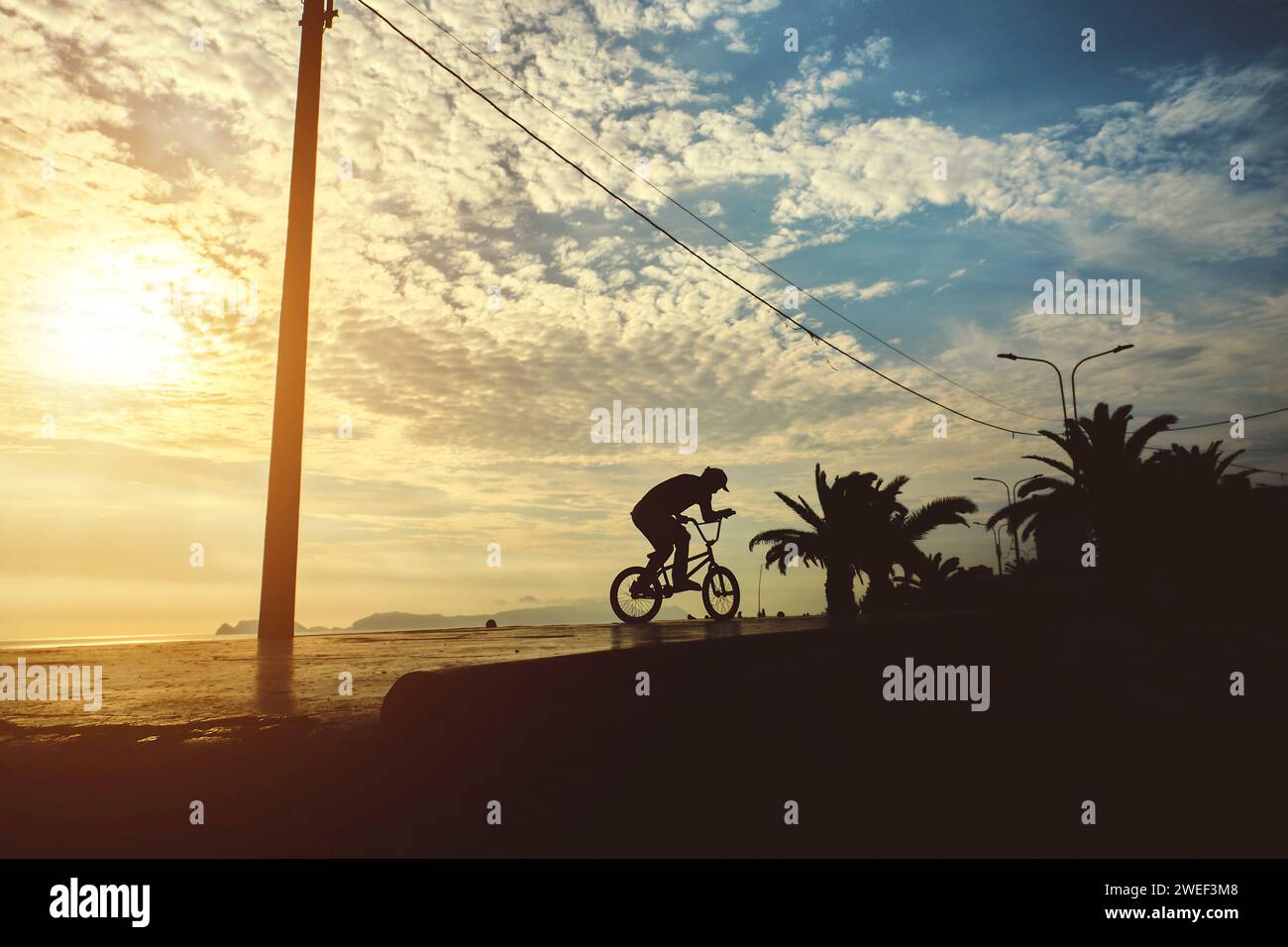 Young man doing ramp jump stunt on bmx bicycle on sunset. Silhouette ...