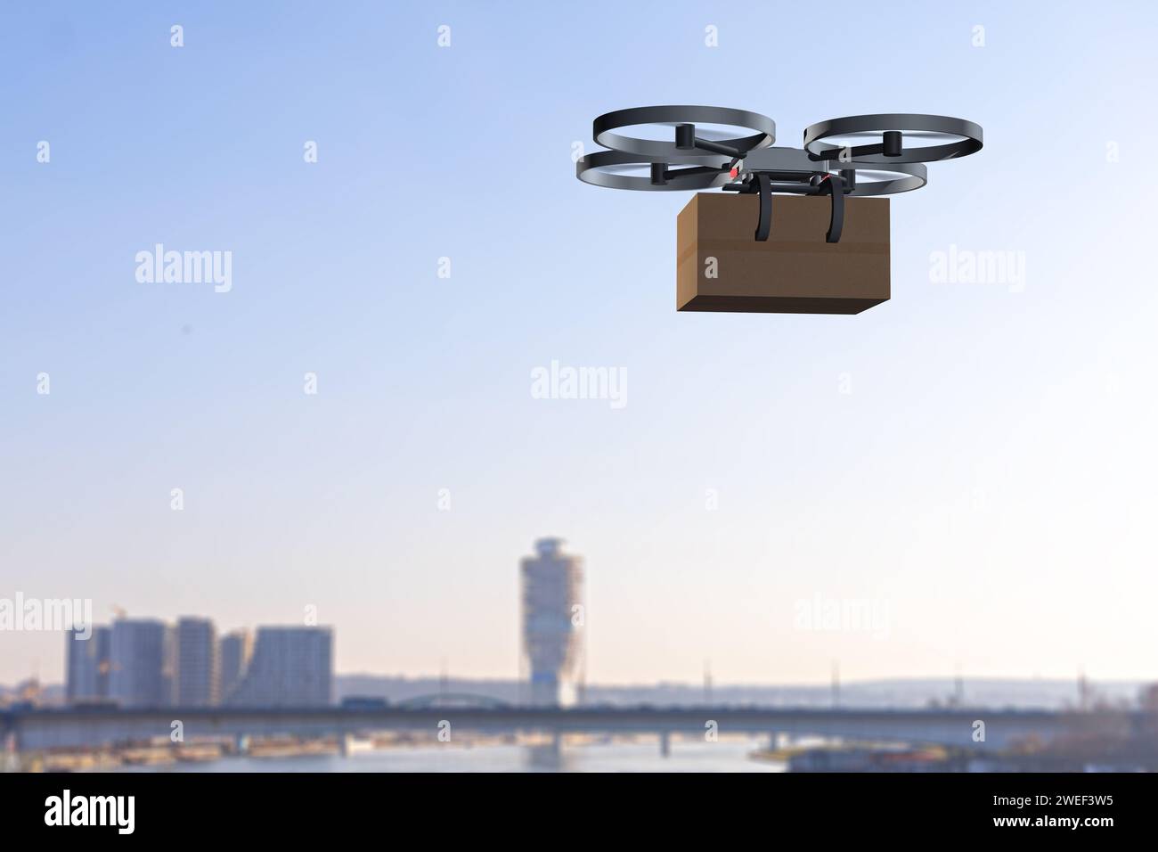 delivery drone carrying a package flying above the city Stock Photo - Alamy