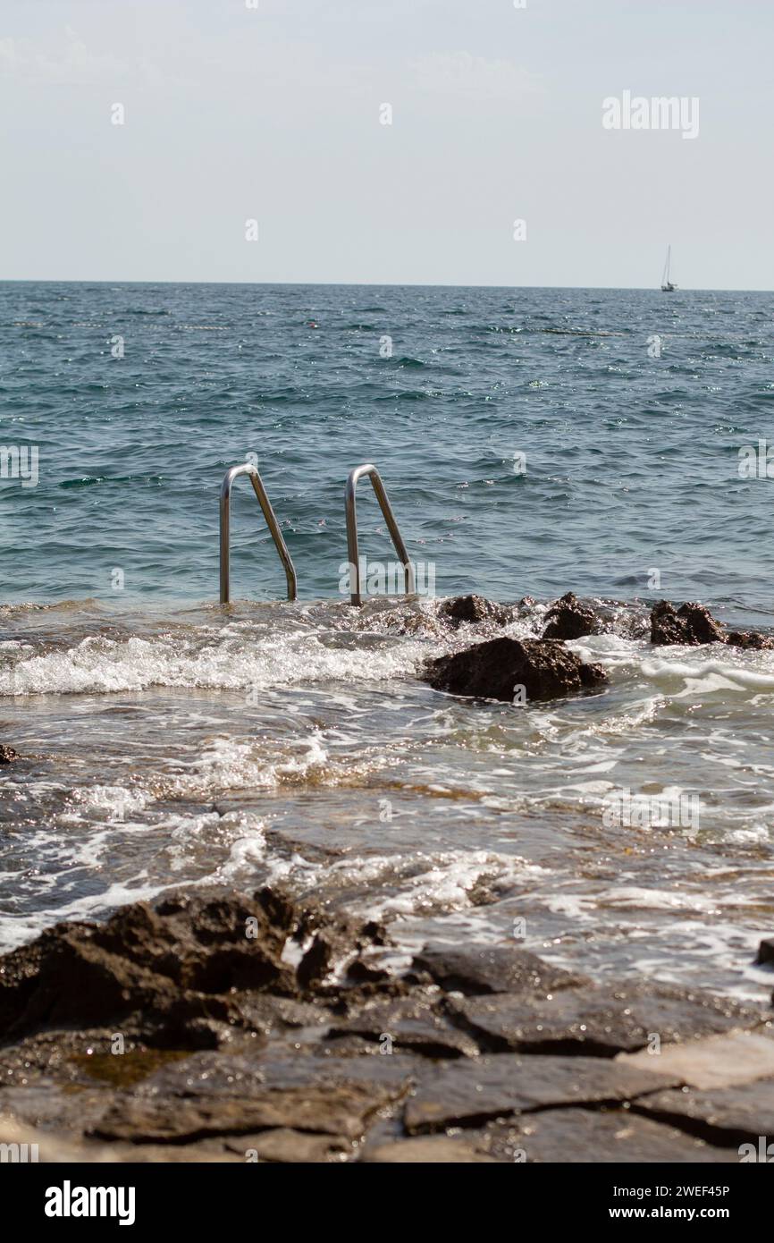entrance into the sea with ladder Stock Photo - Alamy