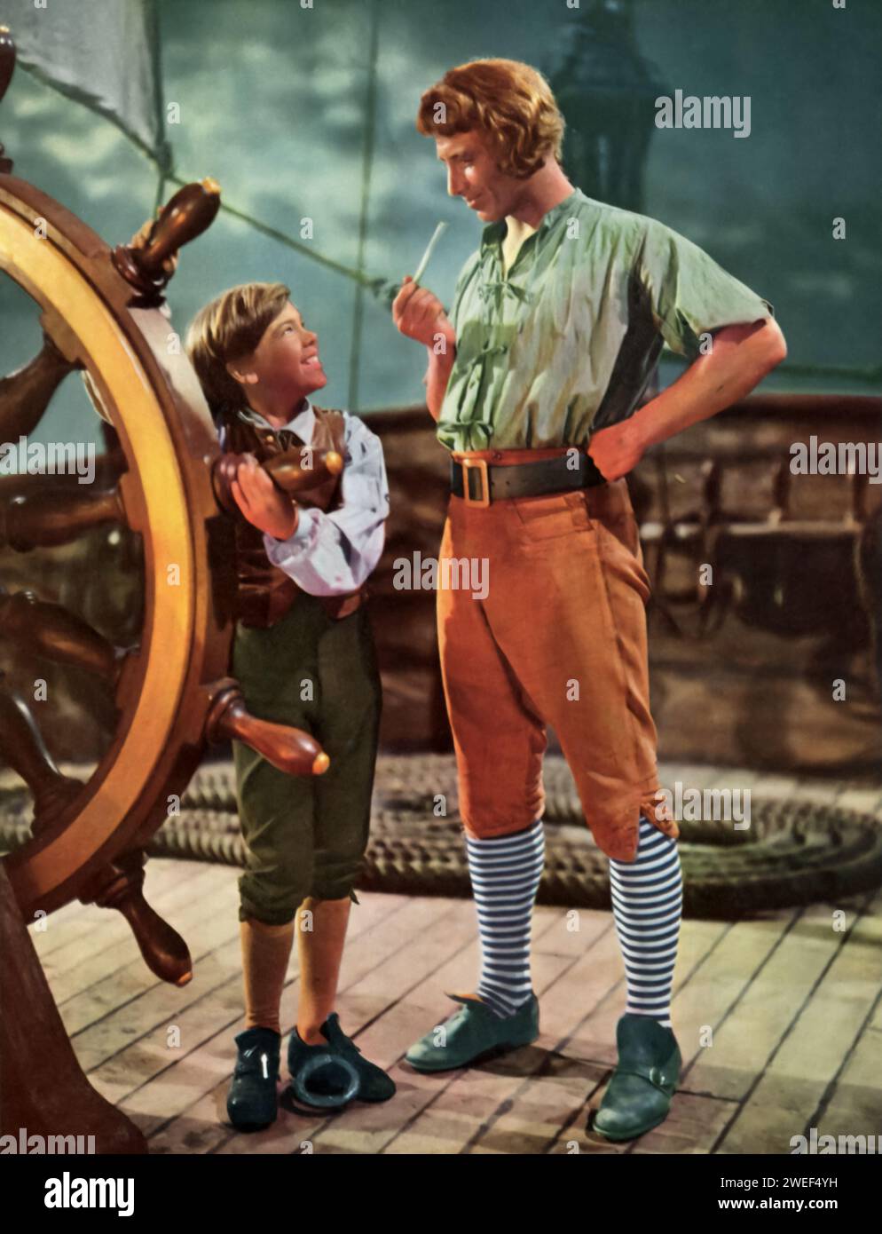 A young Bobby Driscoll plays Jim Hawkins and Andrew Blackett as Gray in ...