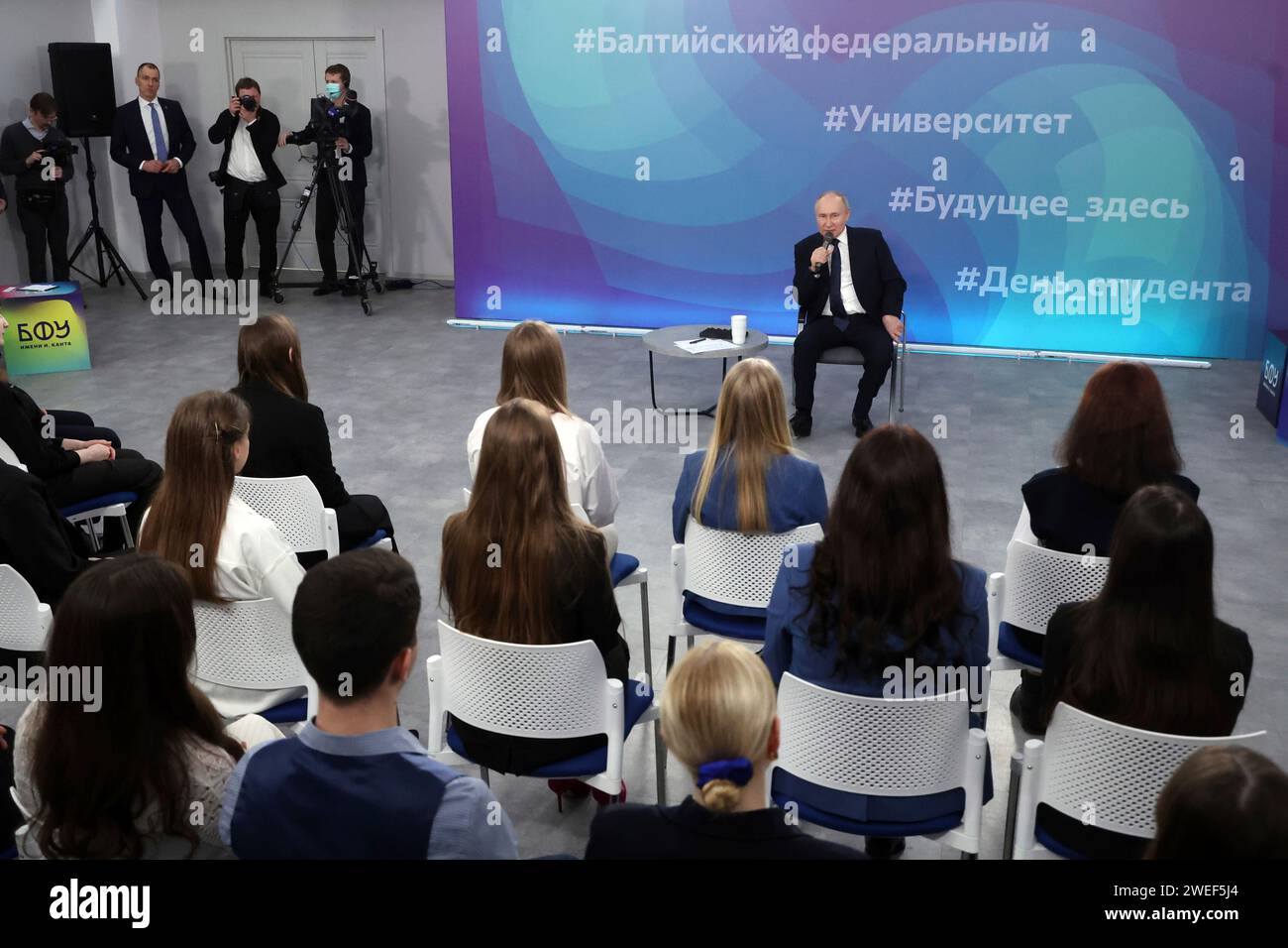 Russian President Vladimir Putin, foreground, speaks to students of the ...