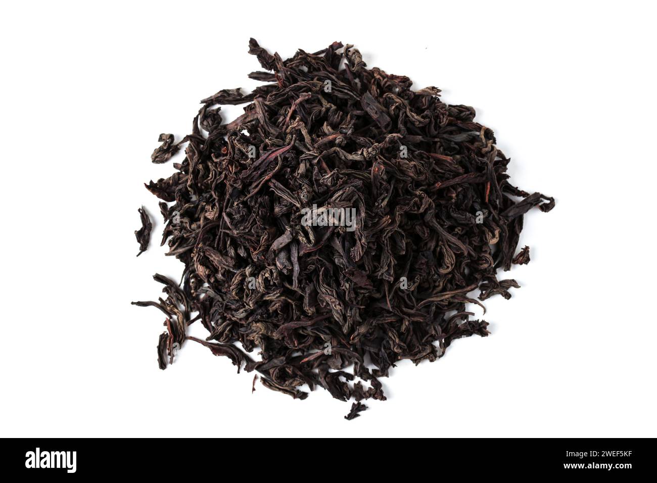 A handful of loose leaf tea in a pile isolated on a white background ...