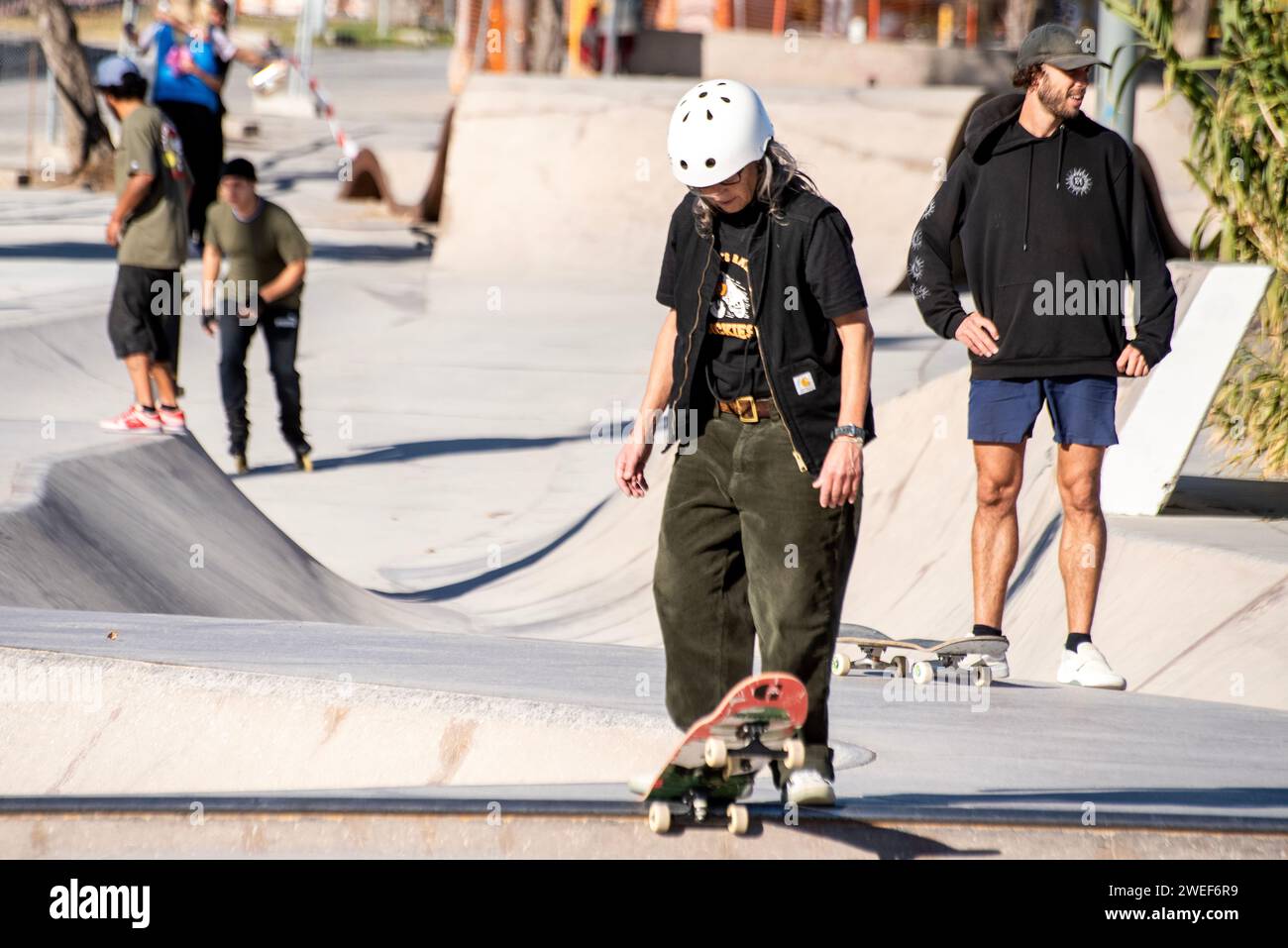 Skate park elegance: A woman skater effortlessly glides, setting the ...