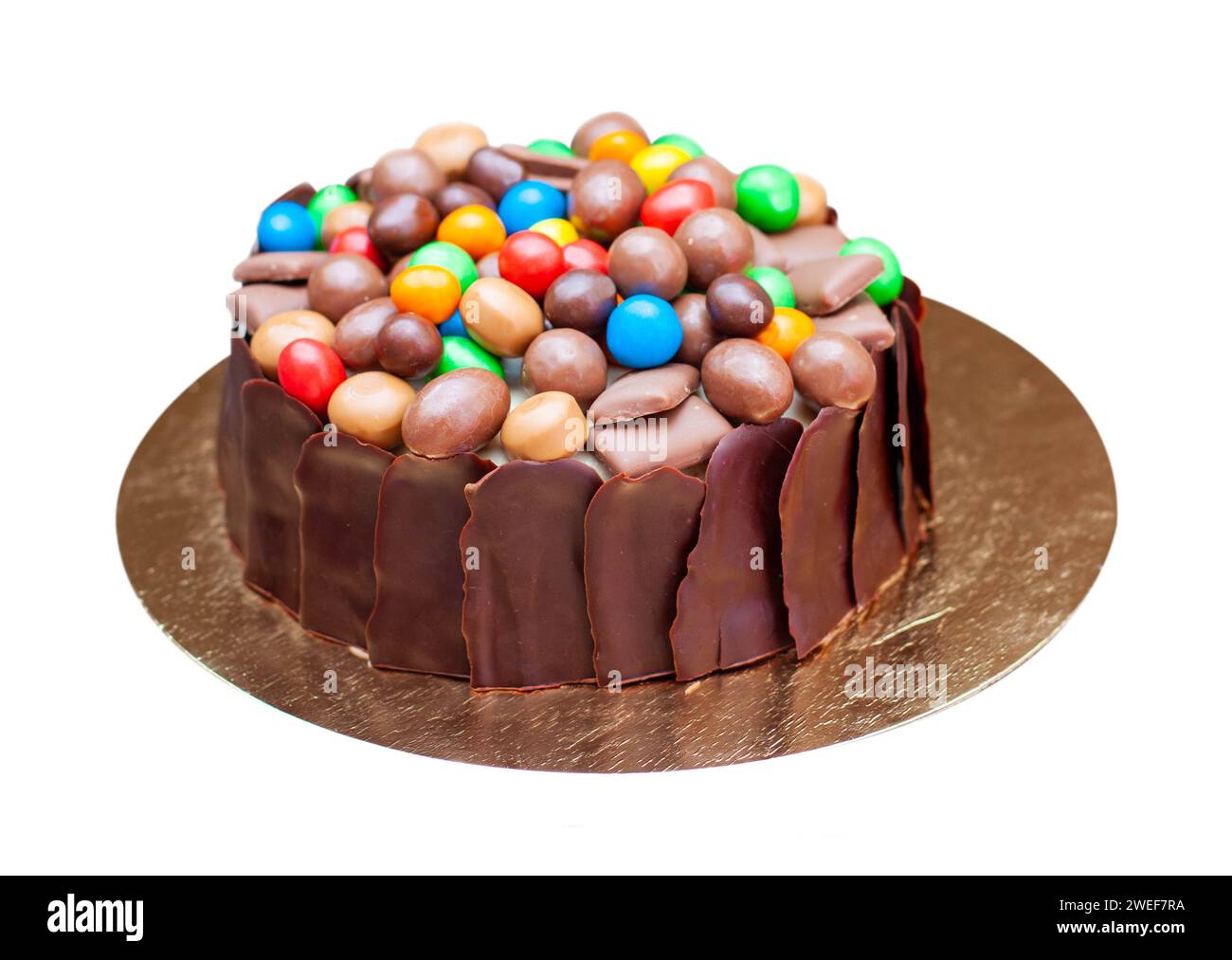 Cake with chocolate fence and scattered colorful chocolate MM bonbon on ...
