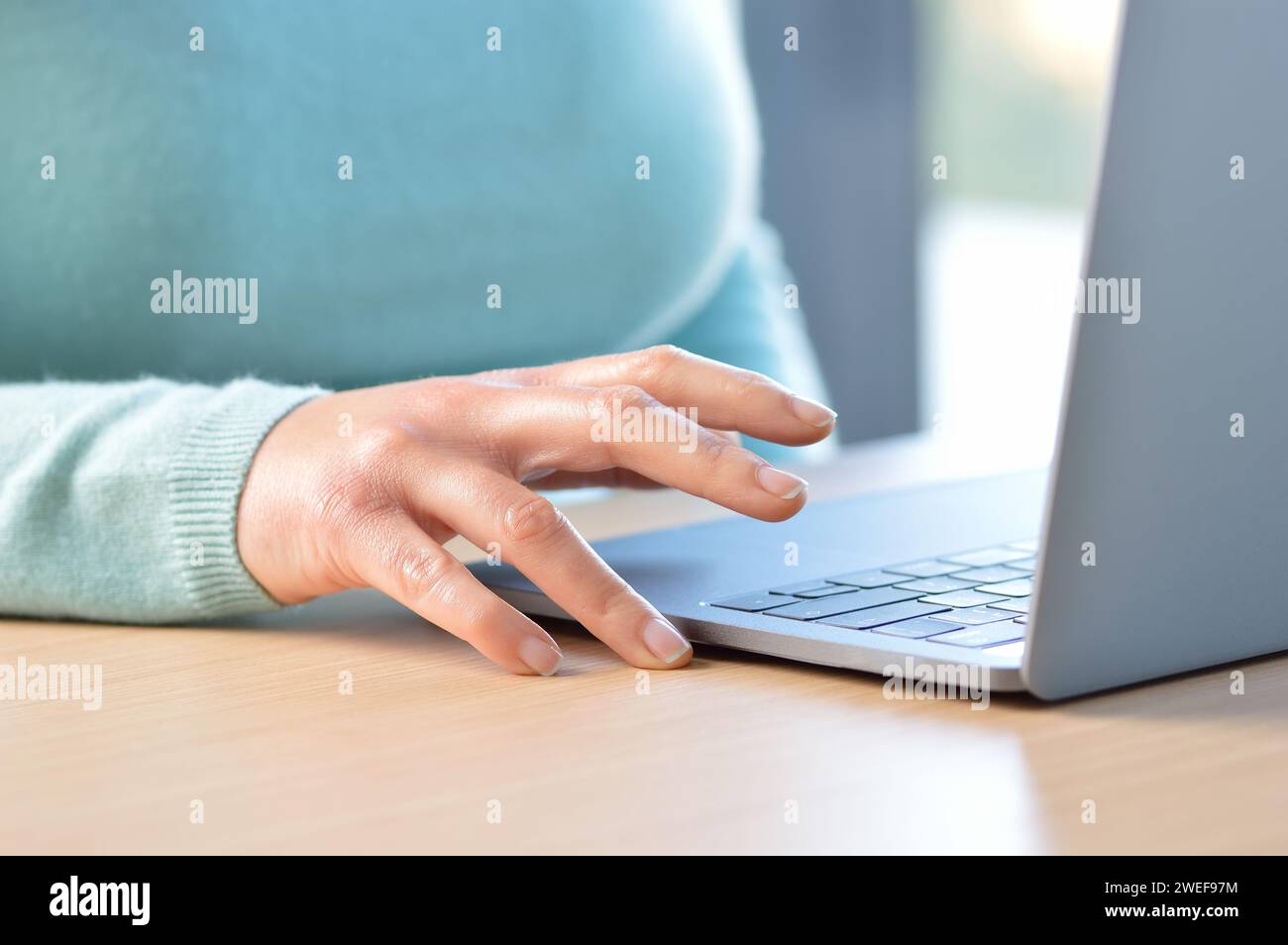 Closeup of woman's hand typing on laptop keypad at office Stock Photo ...