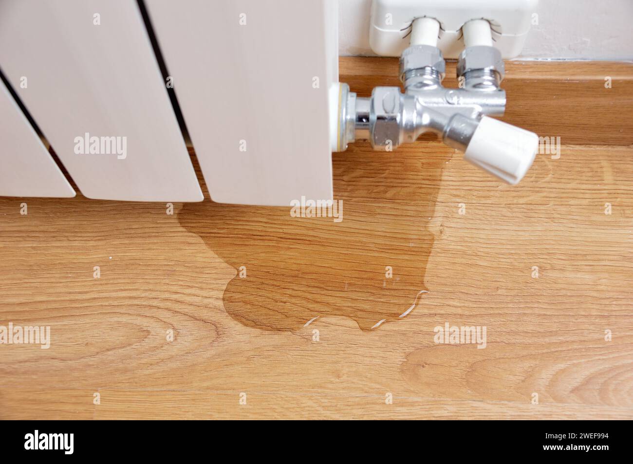 water leak through the heating radiator tube nut Stock Photo - Alamy