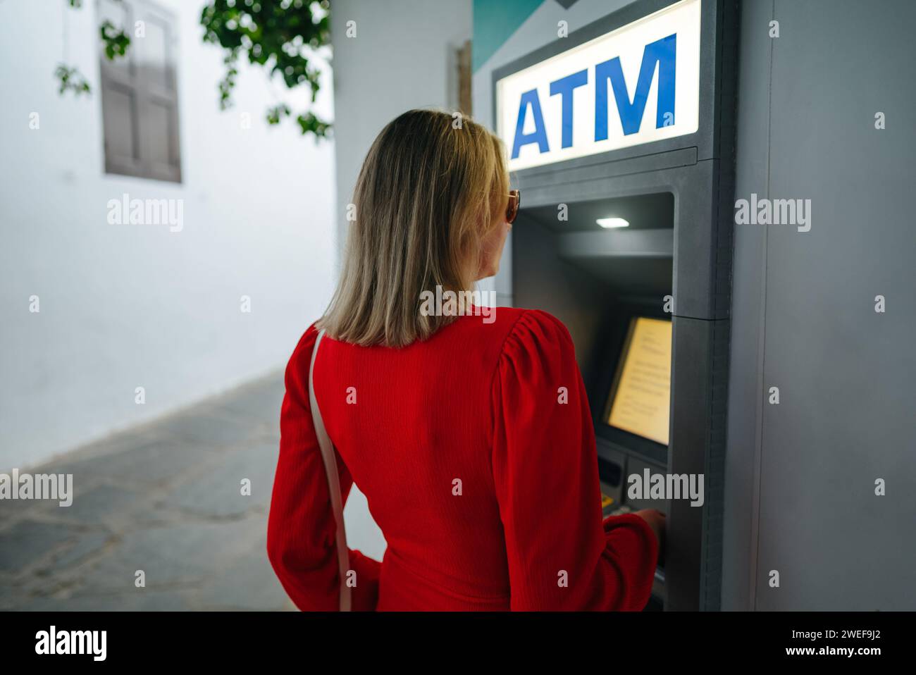 Woman inserting bank card atm hi-res stock photography and images - Alamy