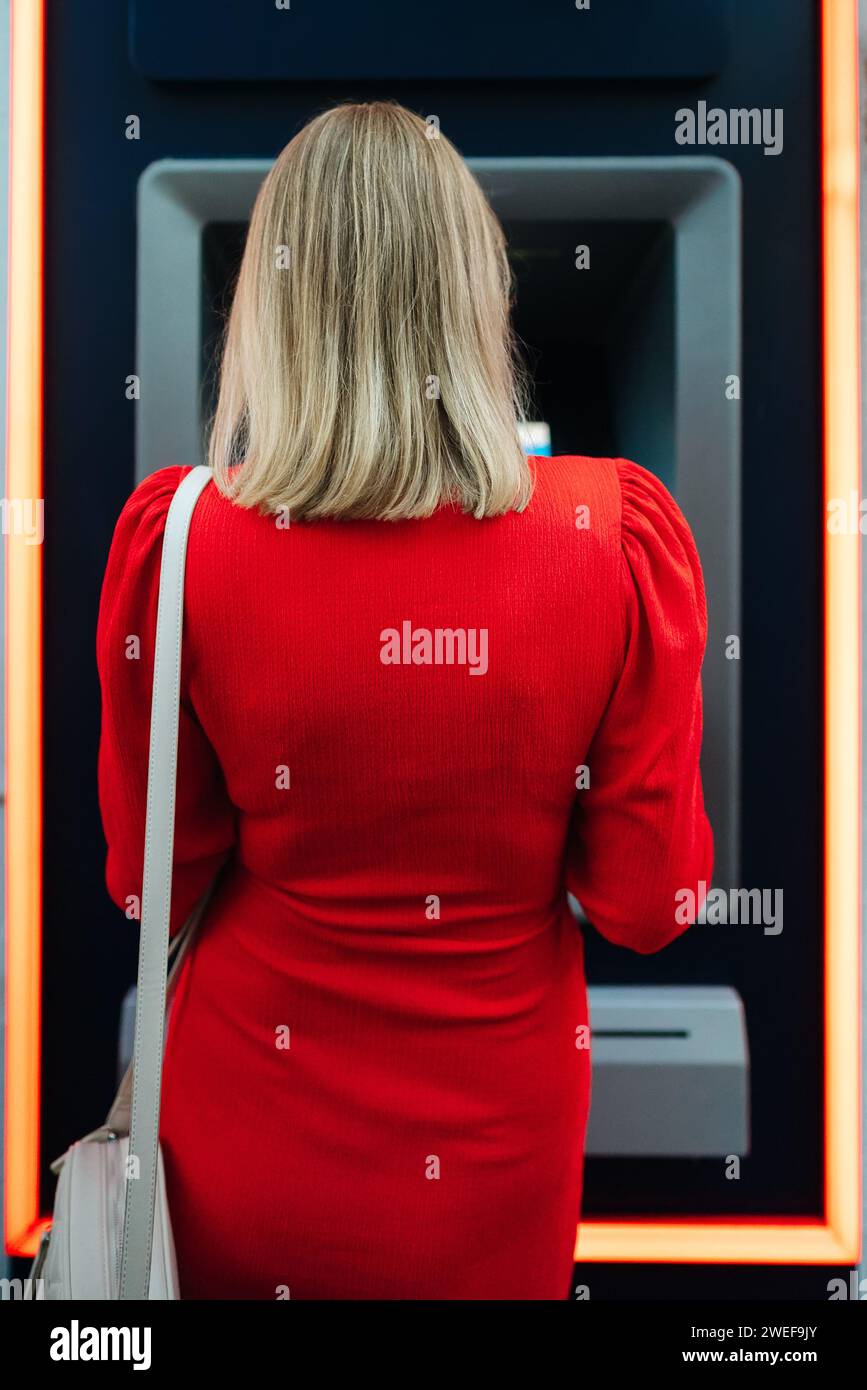 Woman using card red bank banking hi-res stock photography and images ...