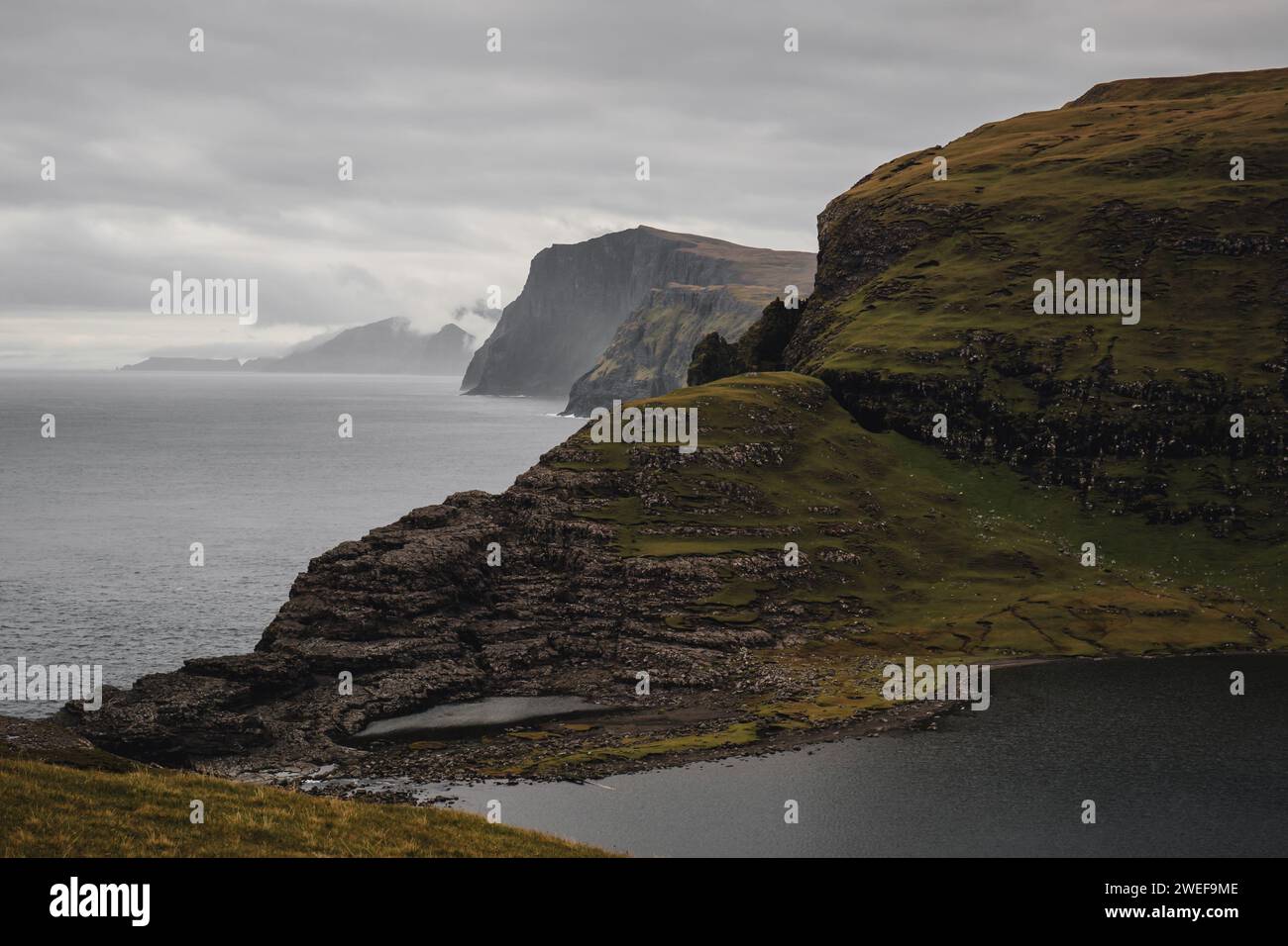 Black cliffs formation in the Atlantic ocean, Faroe Islands. Towering ...