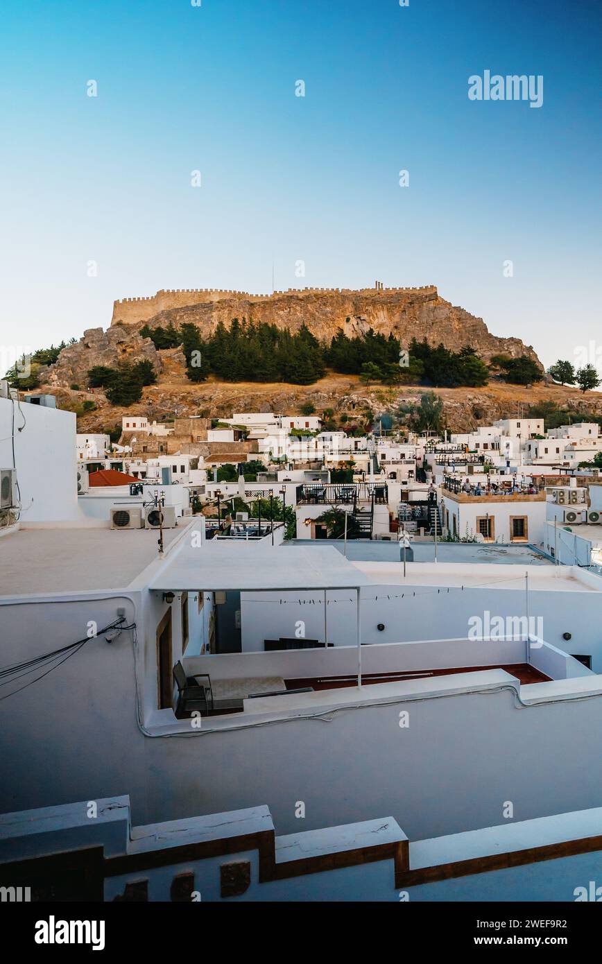 Evening view of the ancient Acropolis of Lindos and snow white houses ...