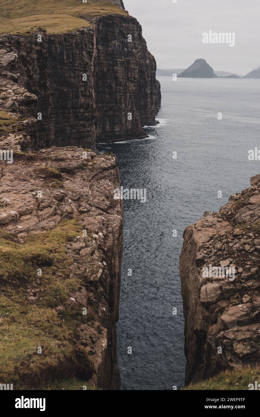 Black cliffs formation in the Atlantic ocean, Faroe Islands. Towering ...