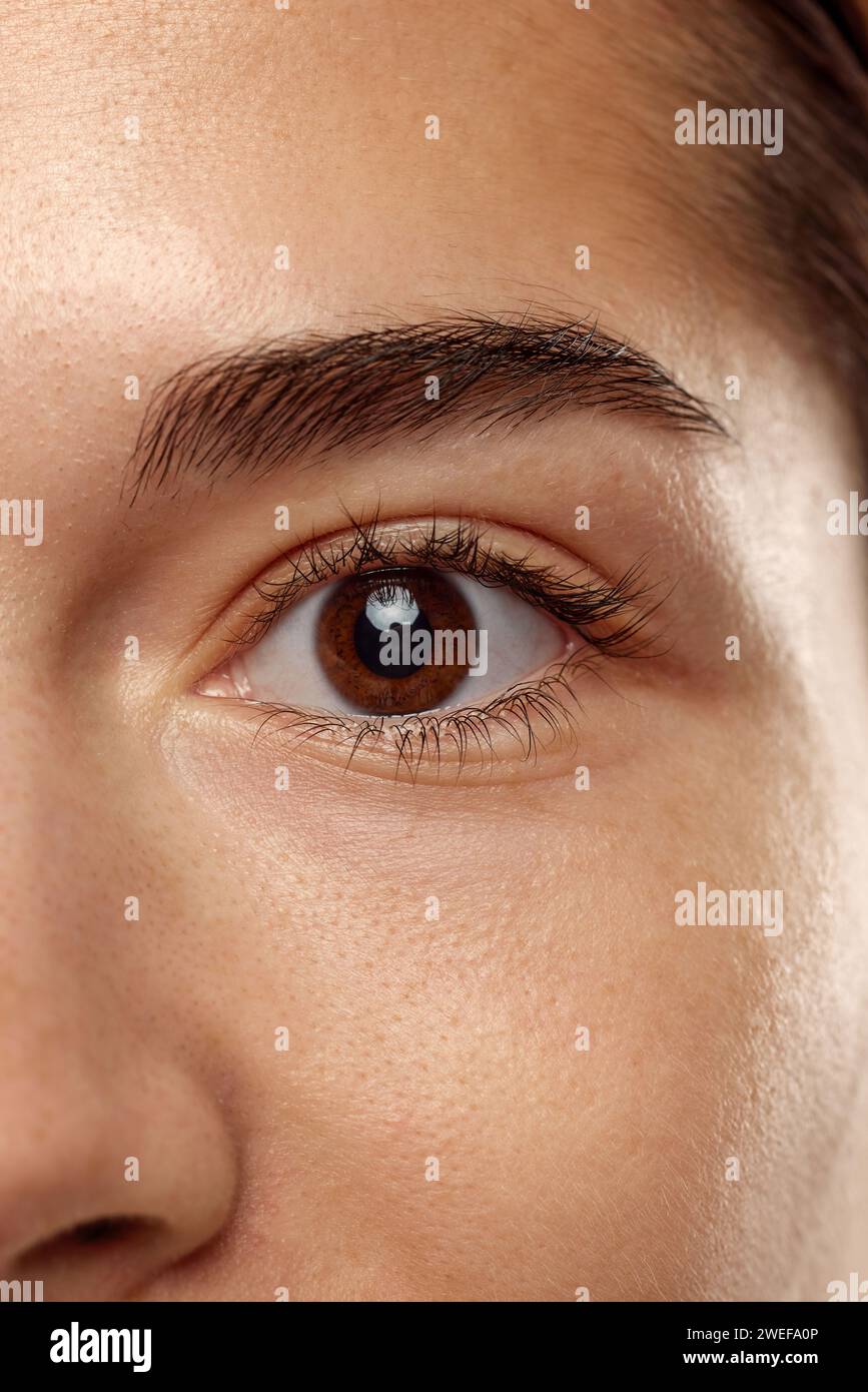 Close-up of female's brown eyes, no makeup looking on camera. Health ...