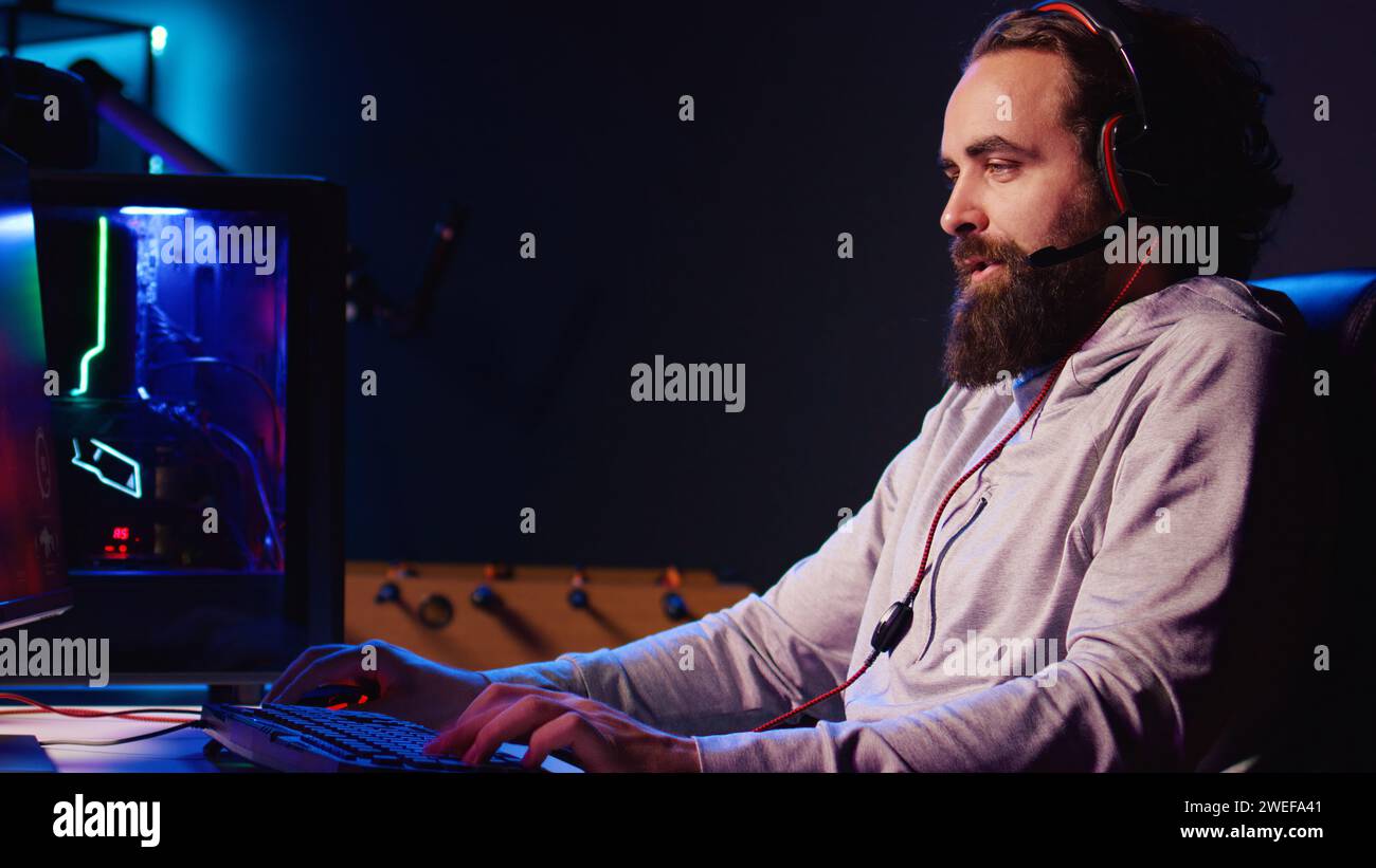 Man enjoying competitive online FPS videogame, battling flying robots ...