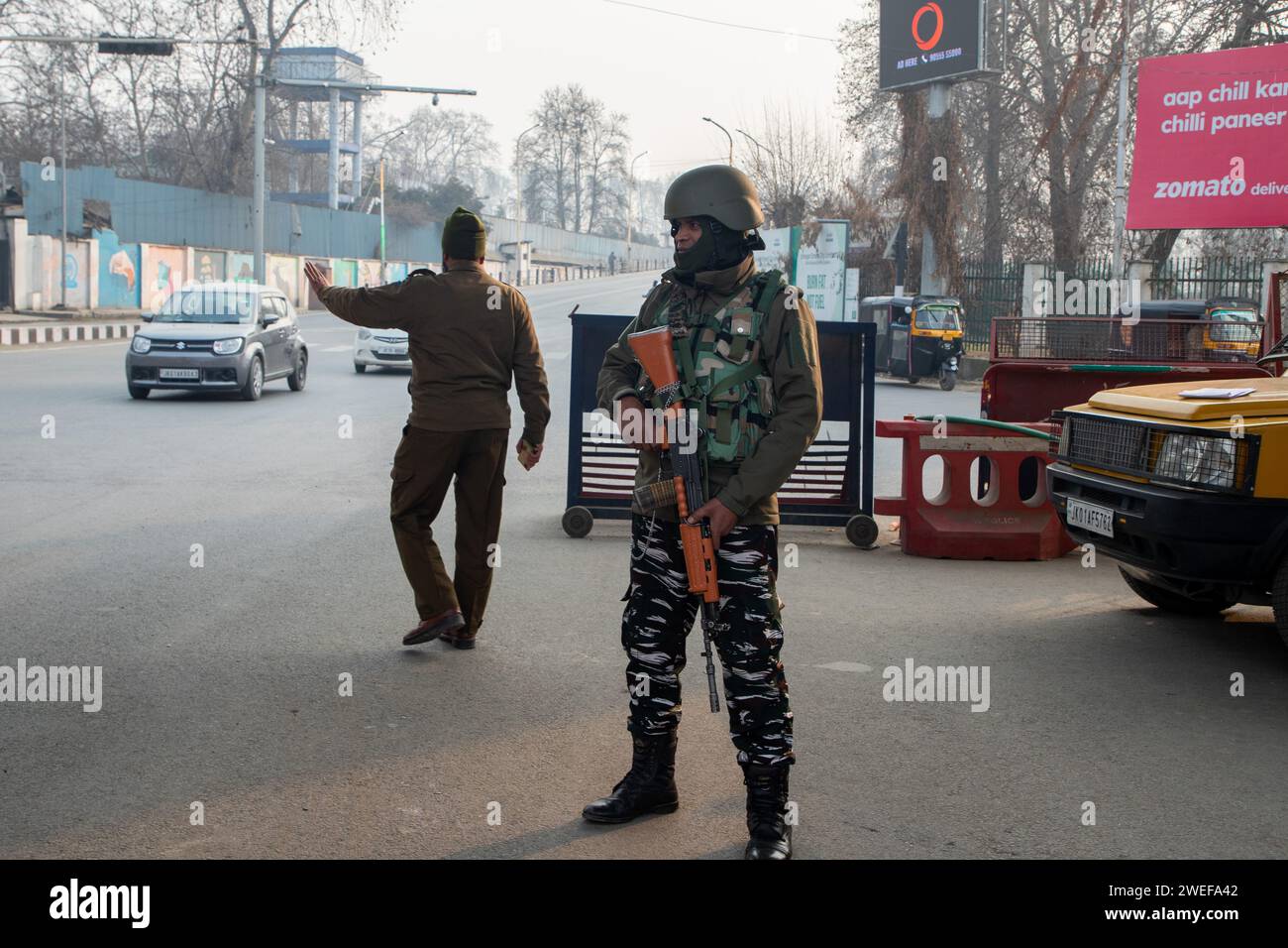 Indian paramilitary trooper frisks a car during random search operation ...