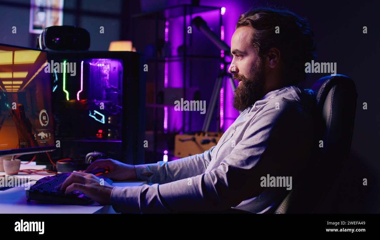 Man enjoying competitive online FPS videogame, battling flying robots ...