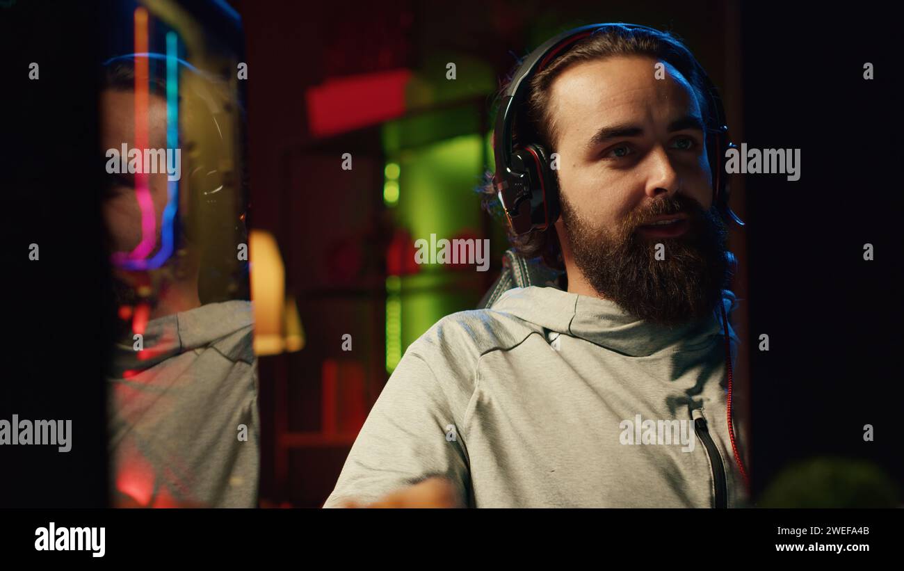 Cheerful gamer strategizing with teammates while playing competitive ...