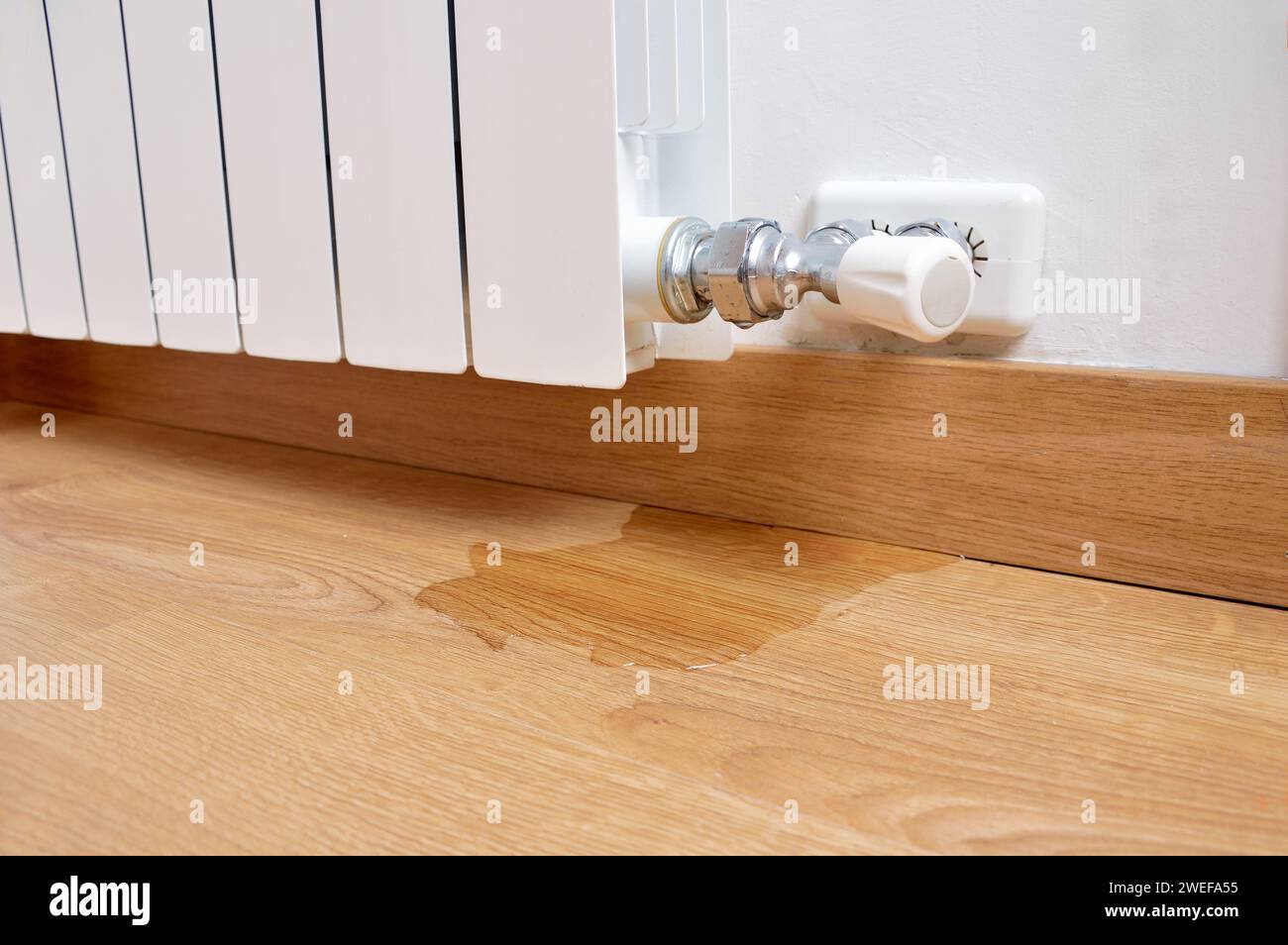 water leak through the heating radiator tube nut Stock Photo - Alamy
