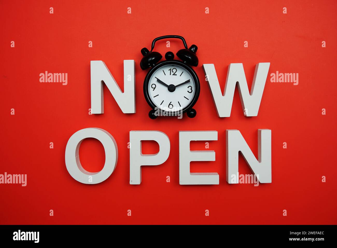 Now Open alphabet letters on red background Stock Photo - Alamy