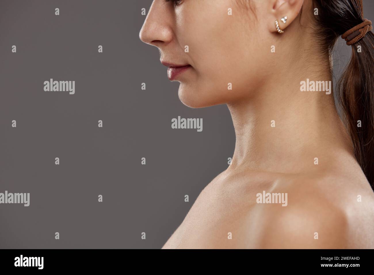 Double chin. Cropped image of female face, profile against studio ...