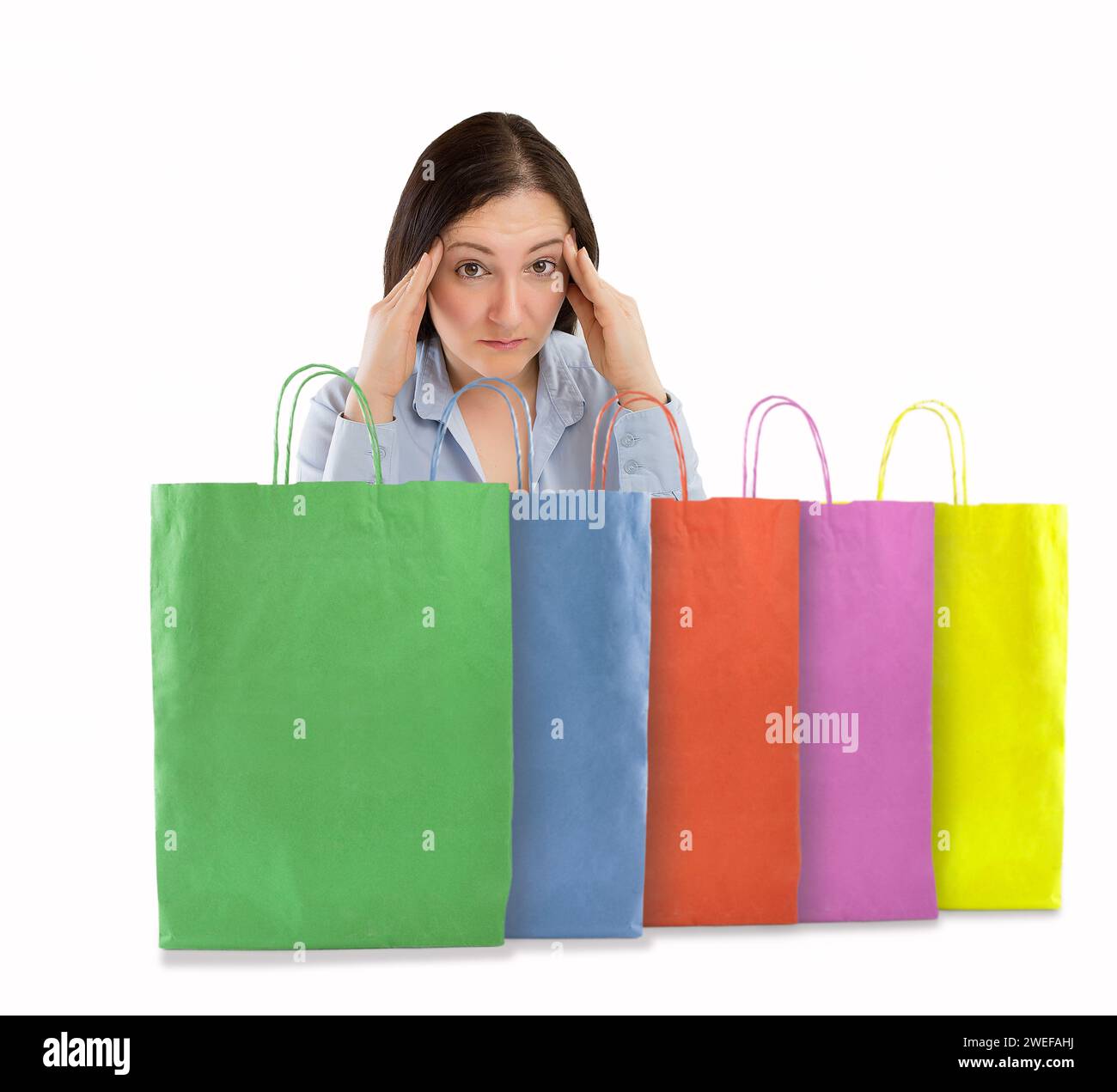Worried shopaholic woman after multiple purchases with white background ...